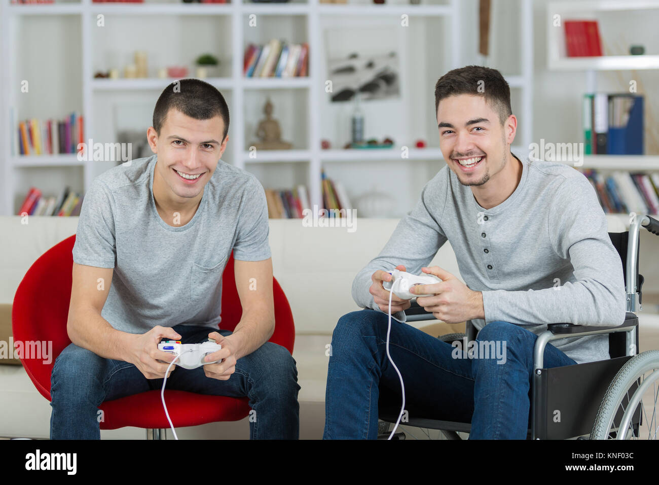 two young men playing video game Stock Photo - Alamy