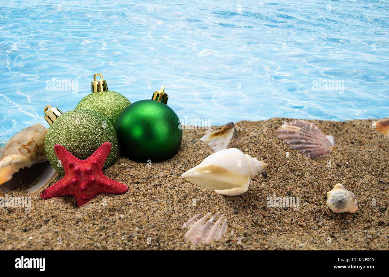 Christmas balls and shells on sand with summer sea background Stock ...