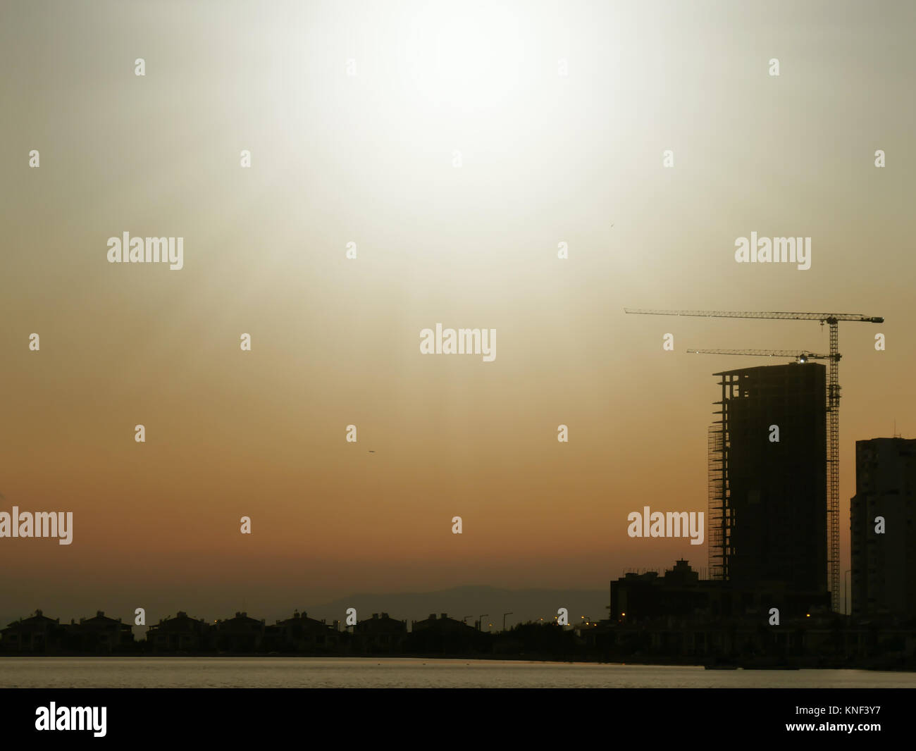 Construction crane and building at sunset Stock Photo - Alamy
