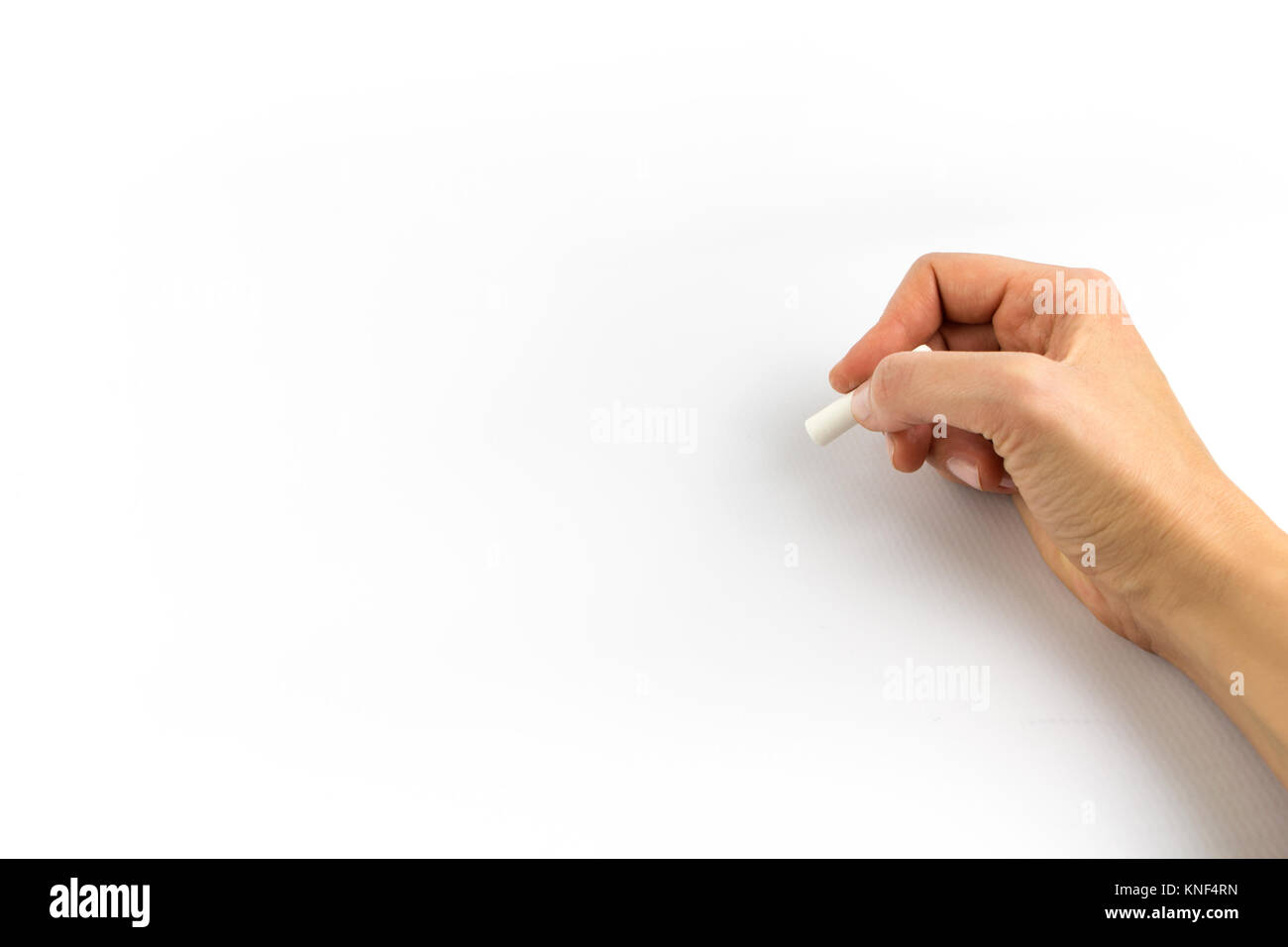 Hand holding chalk isolated on white background Stock Photo - Alamy