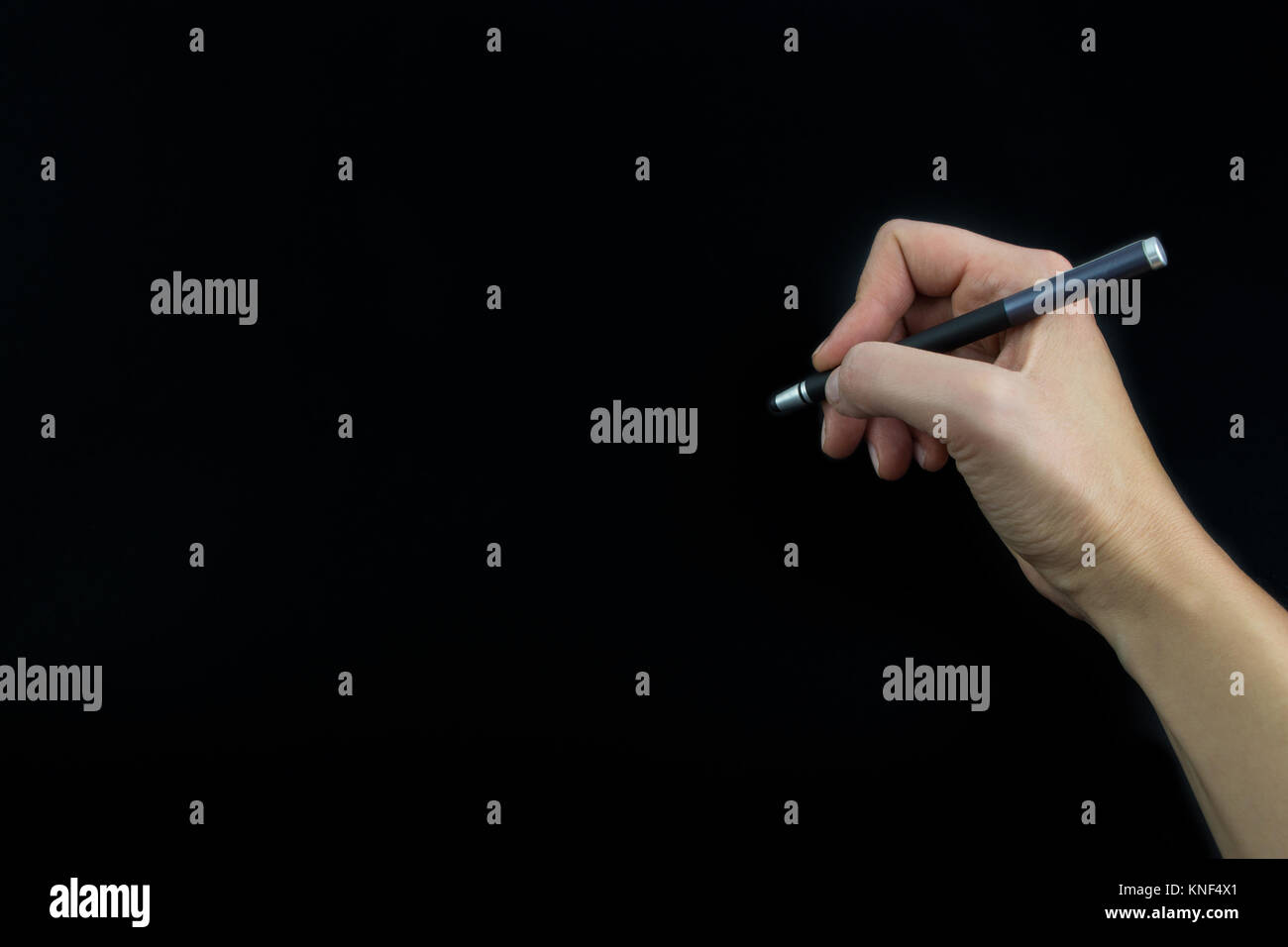 Hand holding stylus isolated on black background Stock Photo - Alamy