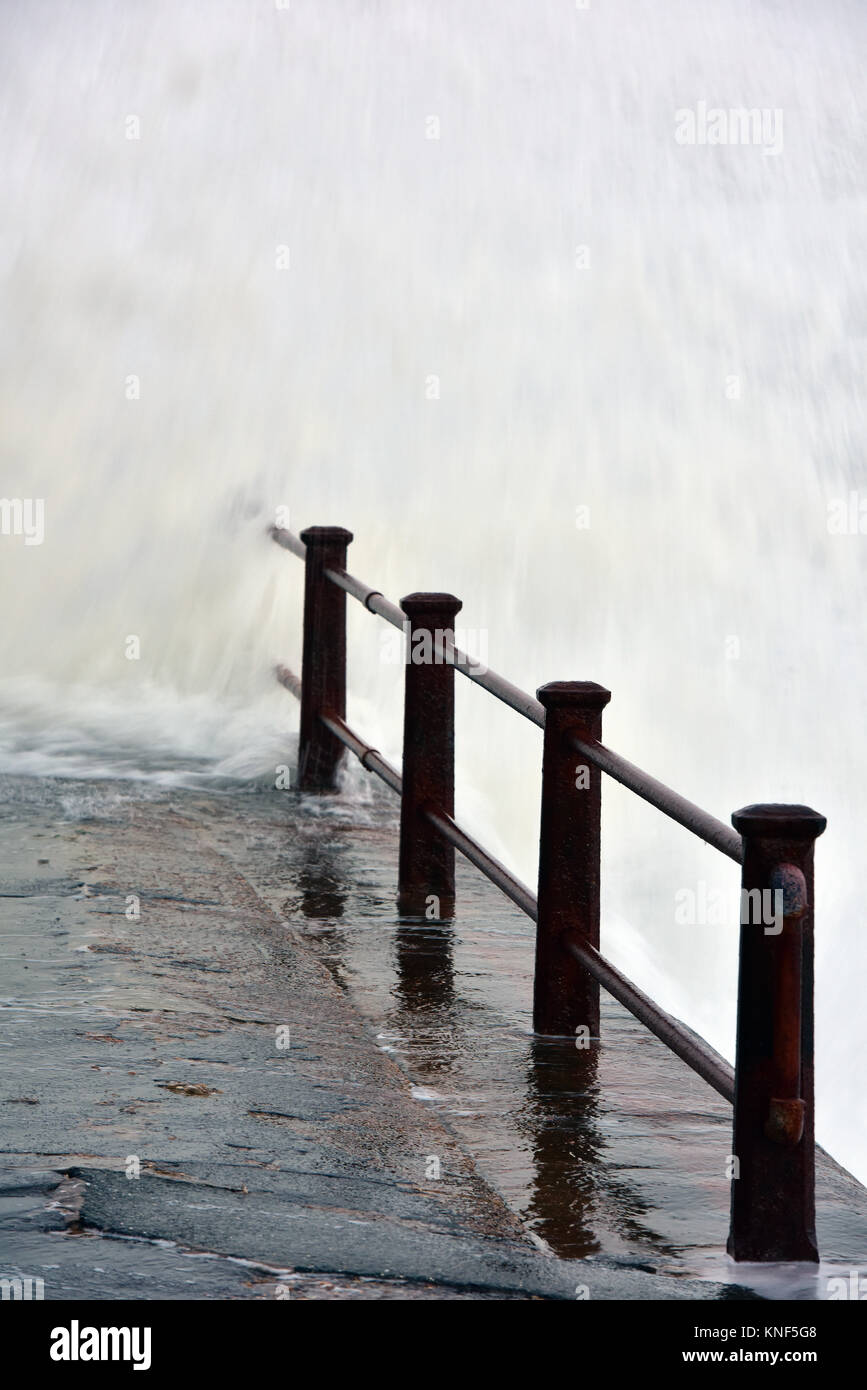 A set of cast iron railings on the seafront getting battered by rough ...