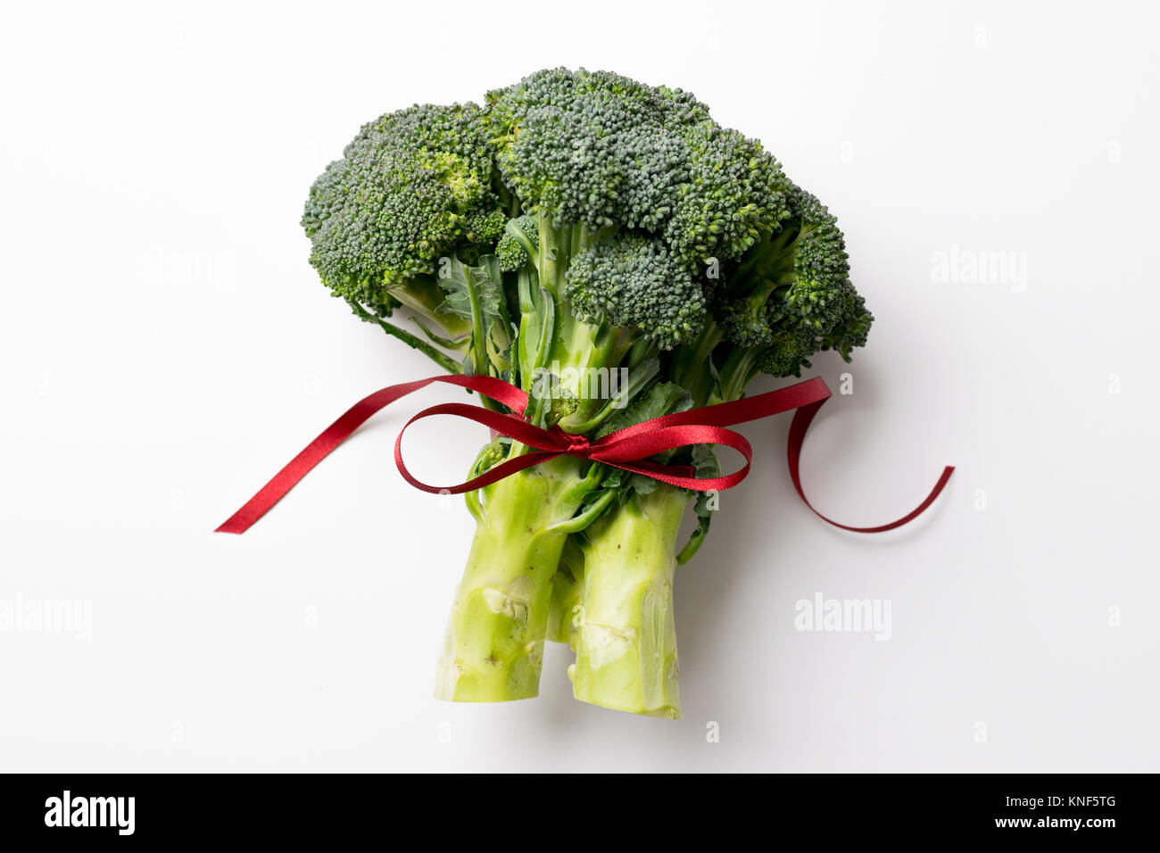Bunch of green broccoli tied with red bow as a healthy gift Stock Photo ...
