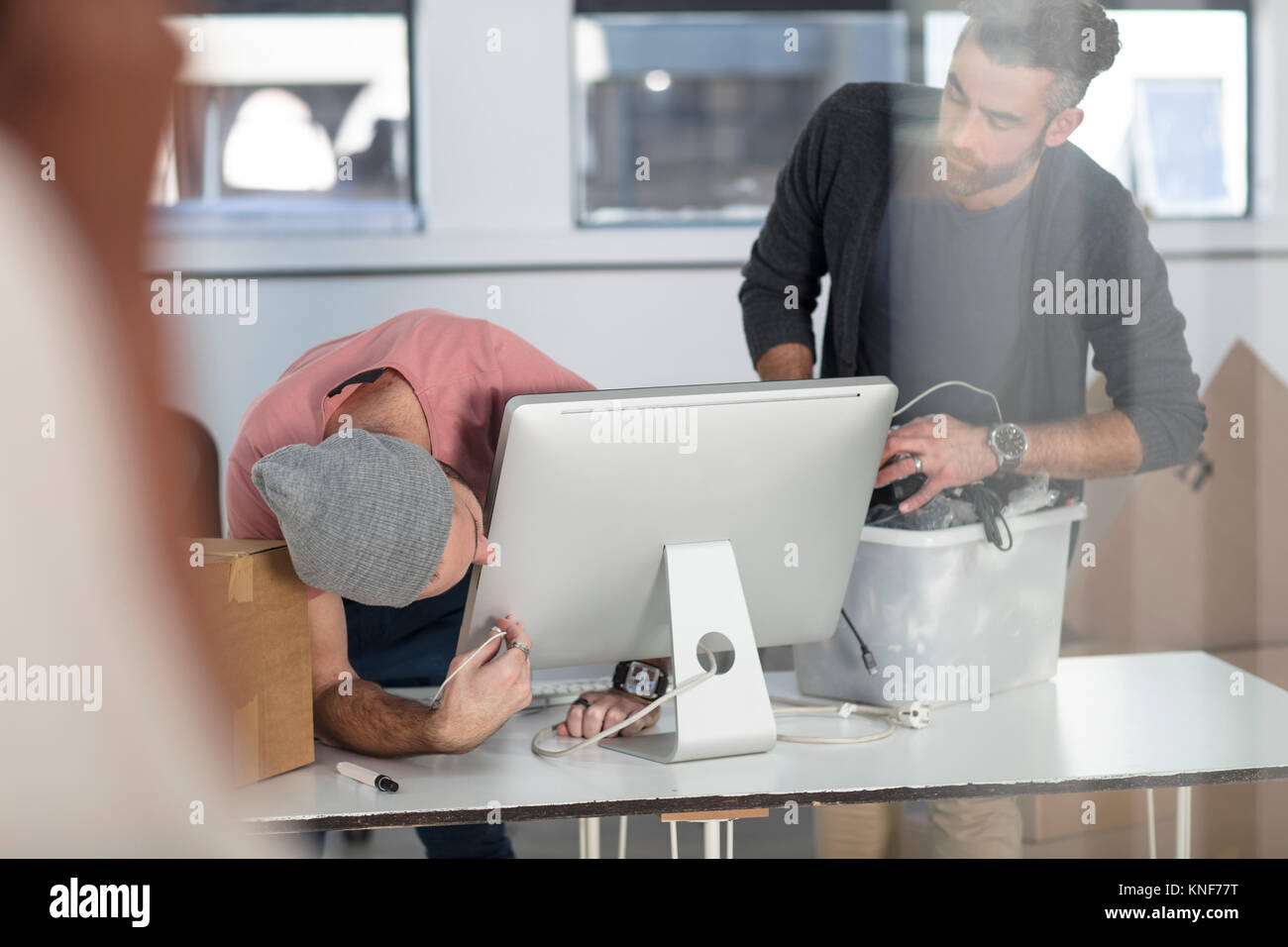 Colleagues in office connecting computer Stock Photo - Alamy