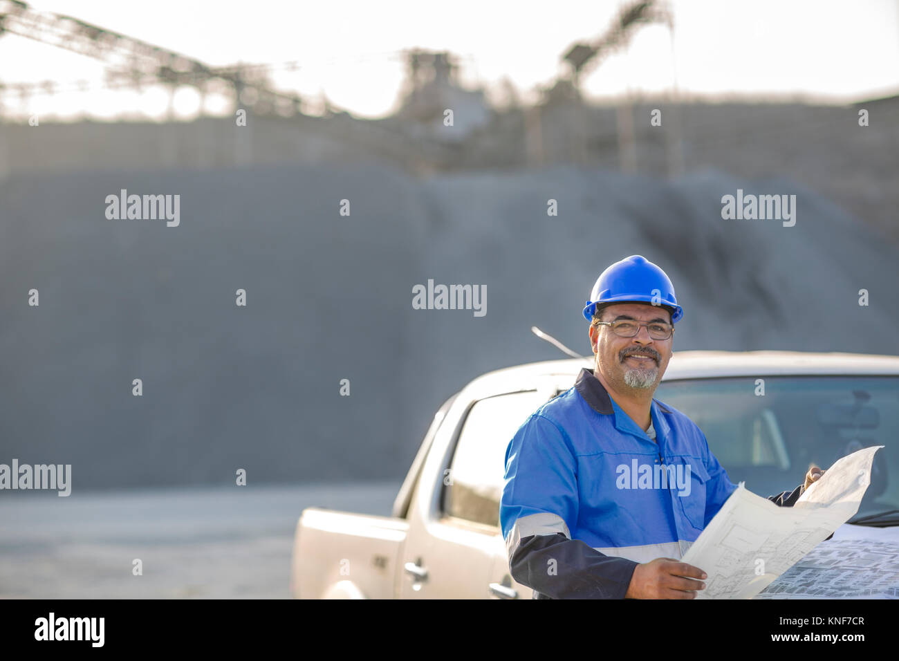 Portrait of quarry worker in quarry, holding document Stock Photo - Alamy