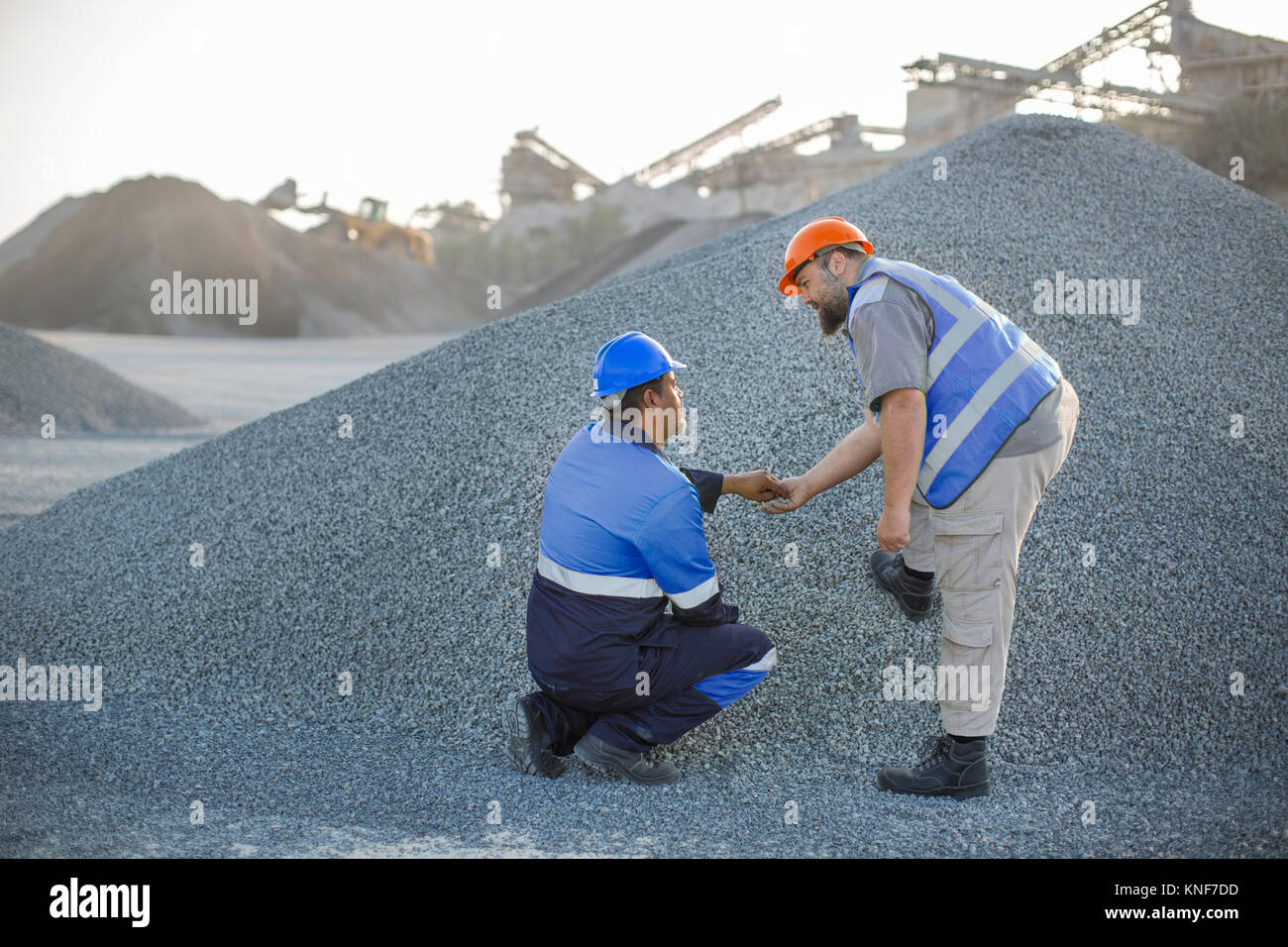 Two quarry workers in quarry, checking aggregate Stock Photo - Alamy