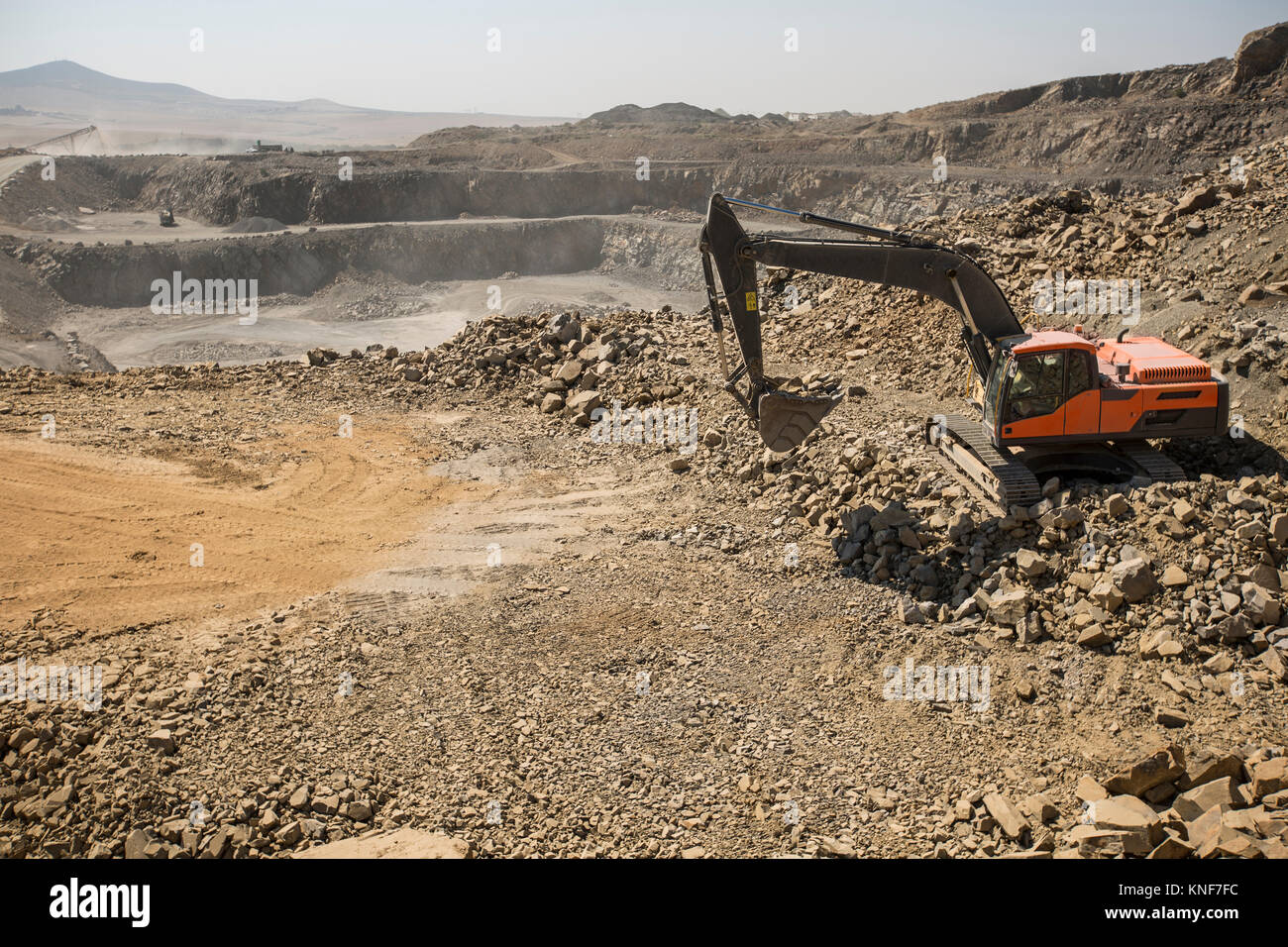 Quarry worker operating heavy machinery in quarry Stock Photo - Alamy