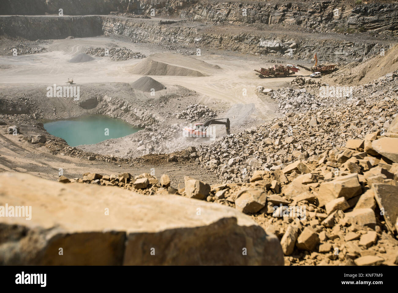 Quarry with heavy machinery in use Stock Photo - Alamy
