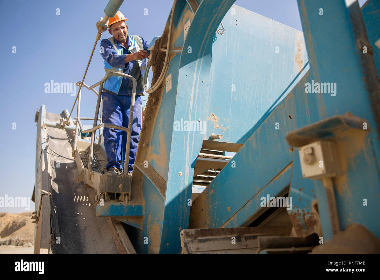 Quarry worker working on heavy machinery Stock Photo - Alamy
