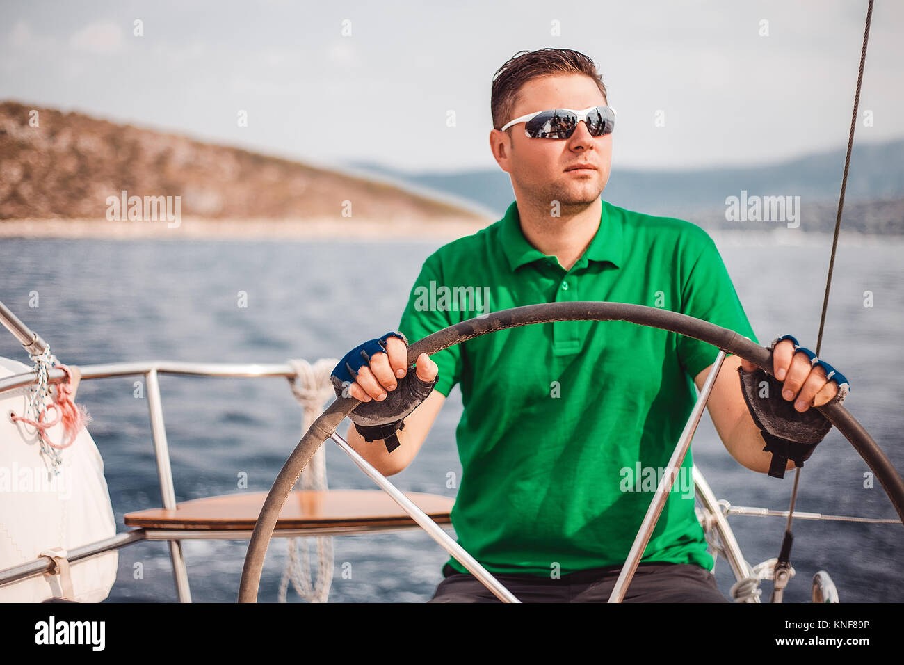 Man sailing sailboat Stock Photo - Alamy