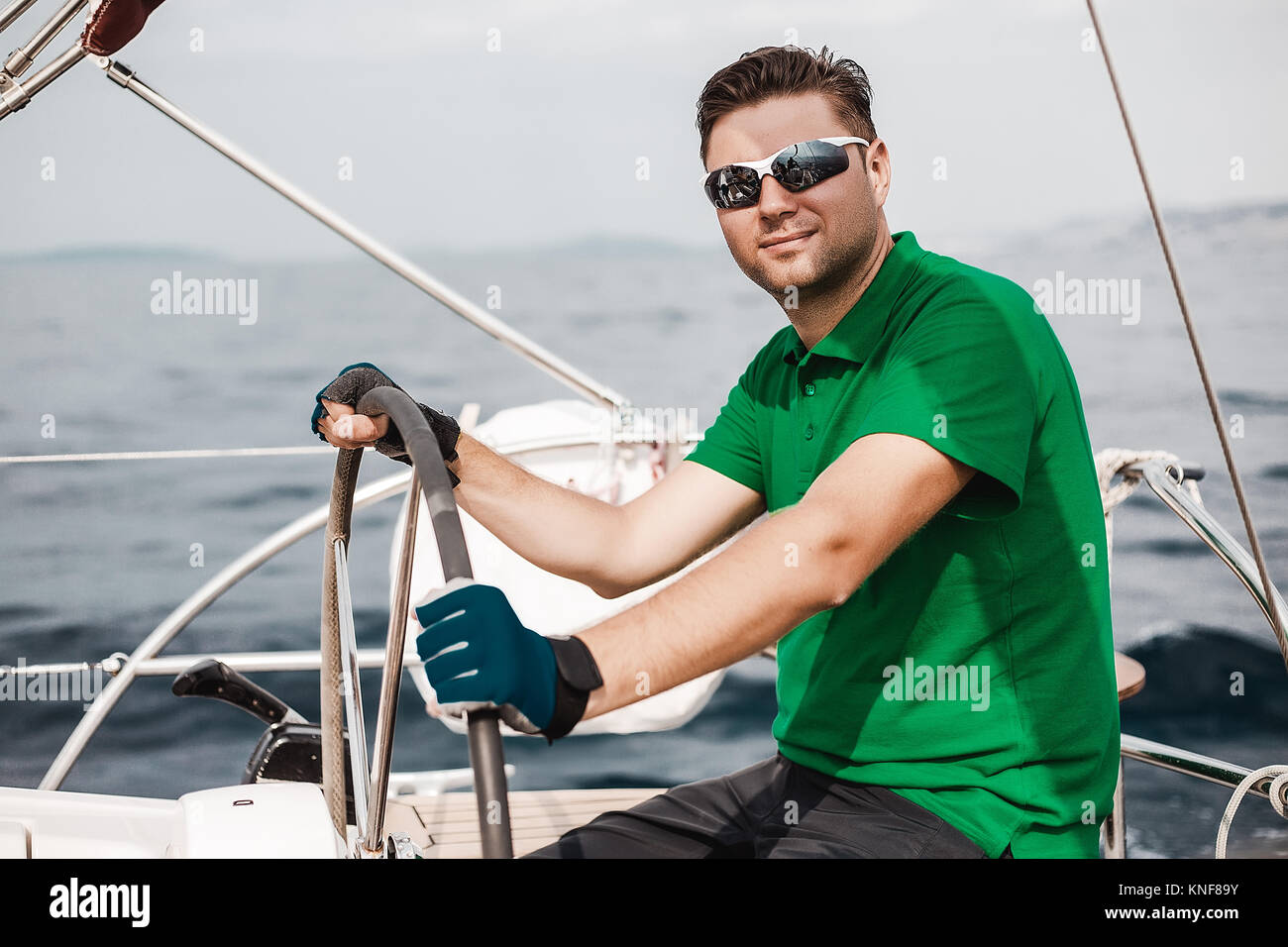 Man sailing sailboat Stock Photo - Alamy