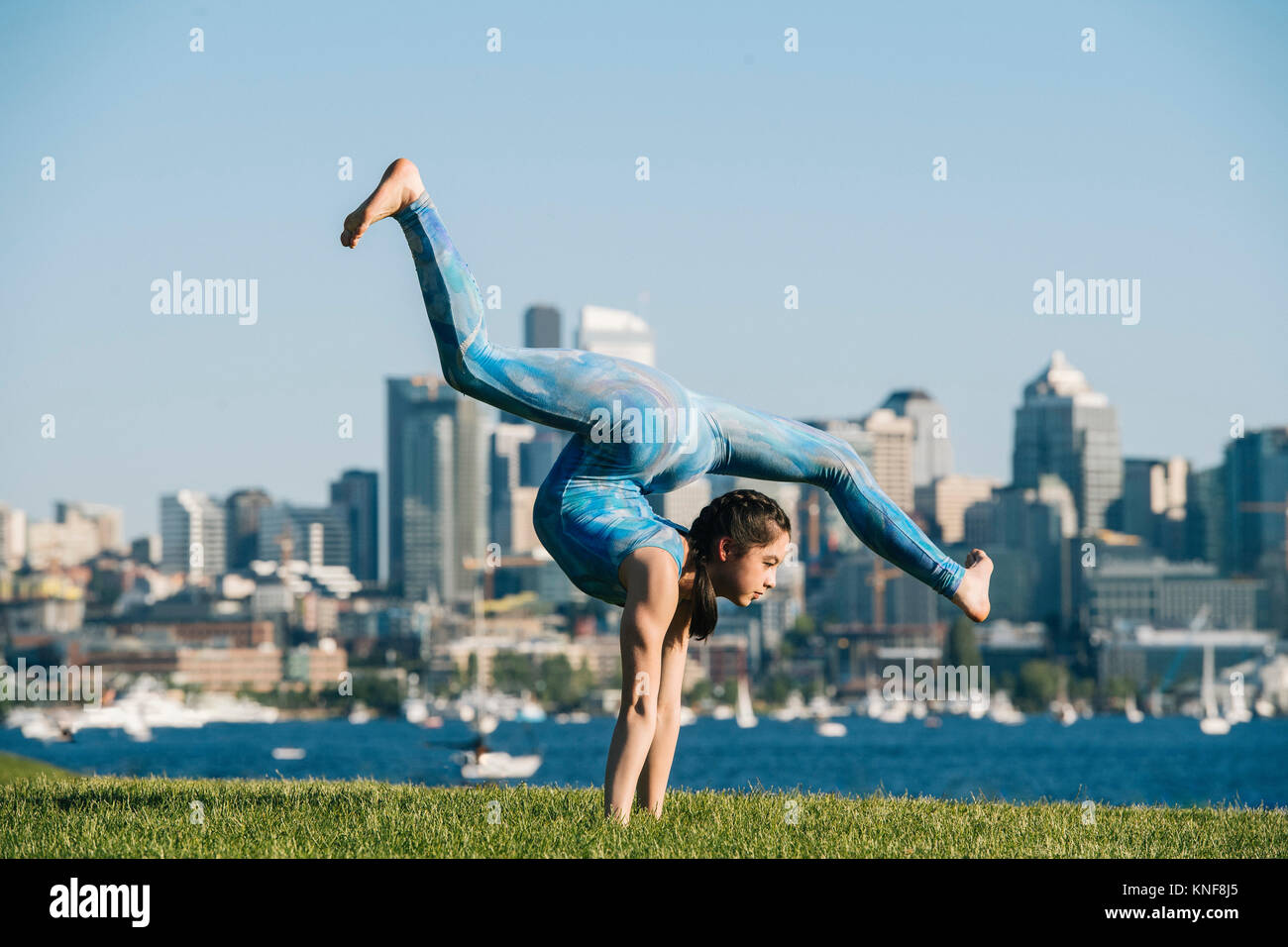Teenage girl outdoors, balancing on hands in yoga position Stock Photo ...