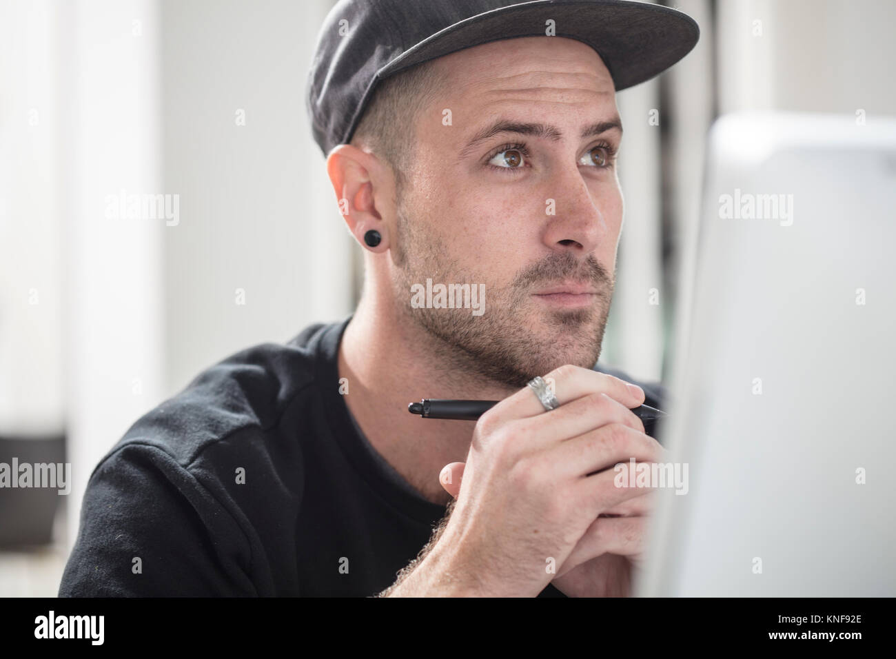 Pensive man using computer Stock Photo - Alamy Pensive man using computer Stock Photo - Alamy