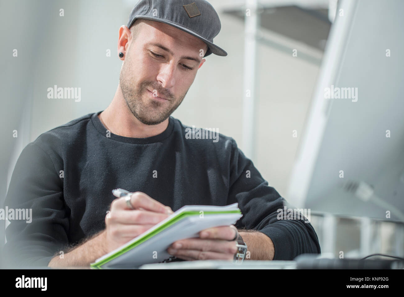 Man writing in notepad Stock Photo - Alamy