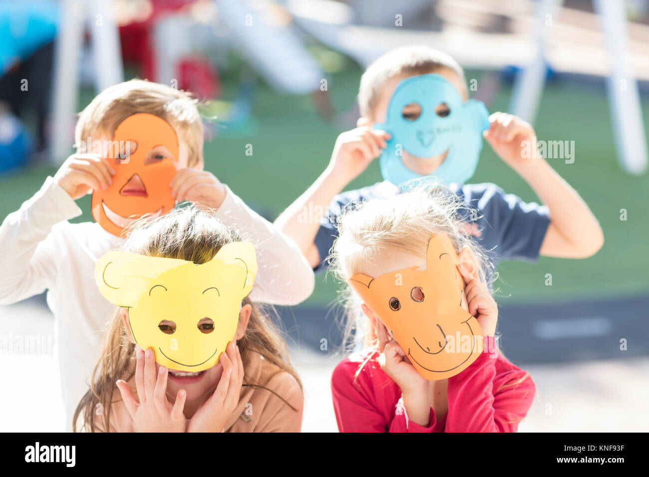 Portrait if four children wearing paper masks Stock Photo - Alamy