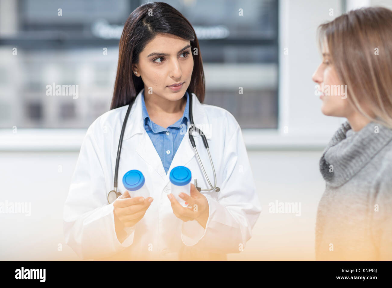 Female doctor having discussion with patient Stock Photo - Alamy