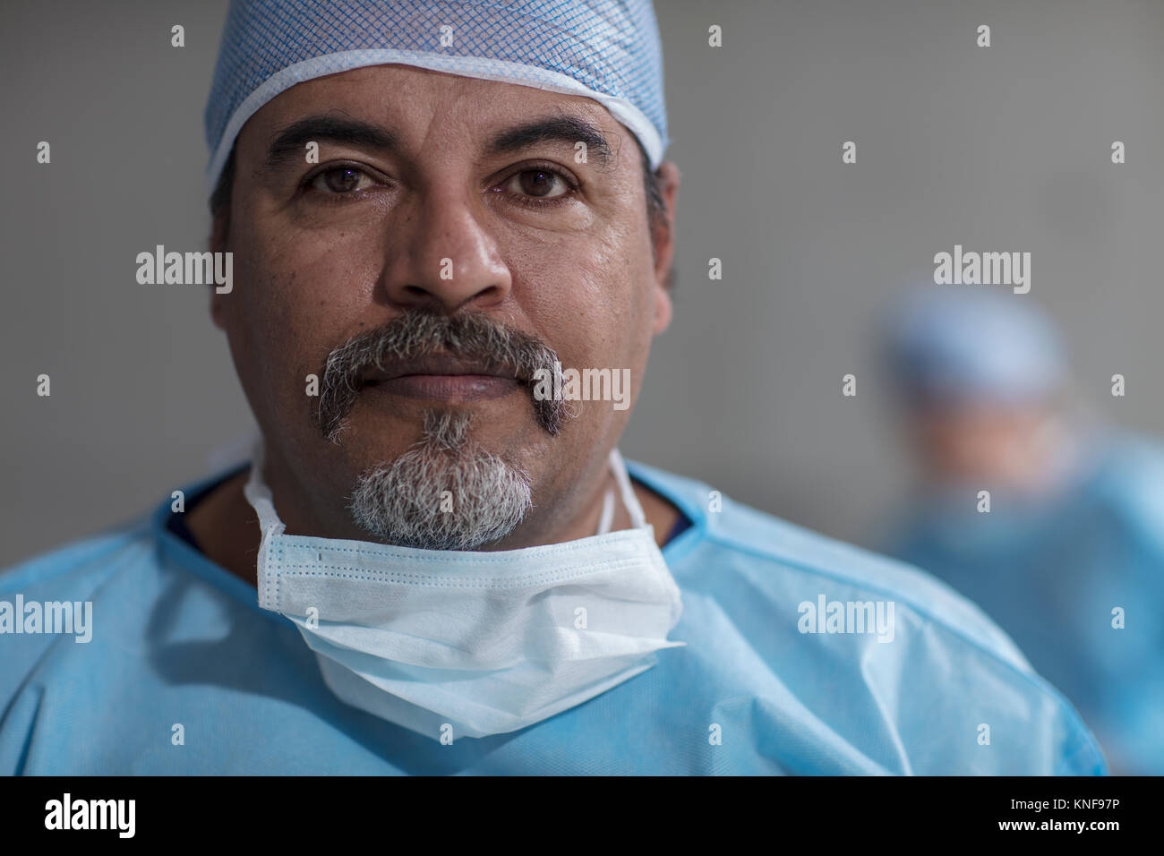 Portrait of male surgeon wearing scrubs and surgical mask Stock Photo ...
