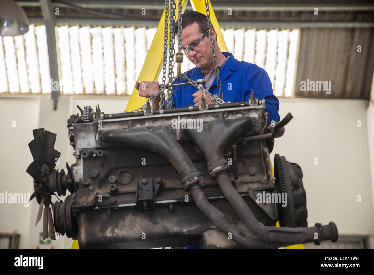 Male car mechanic using wrench on car engine in repair garage Stock ...