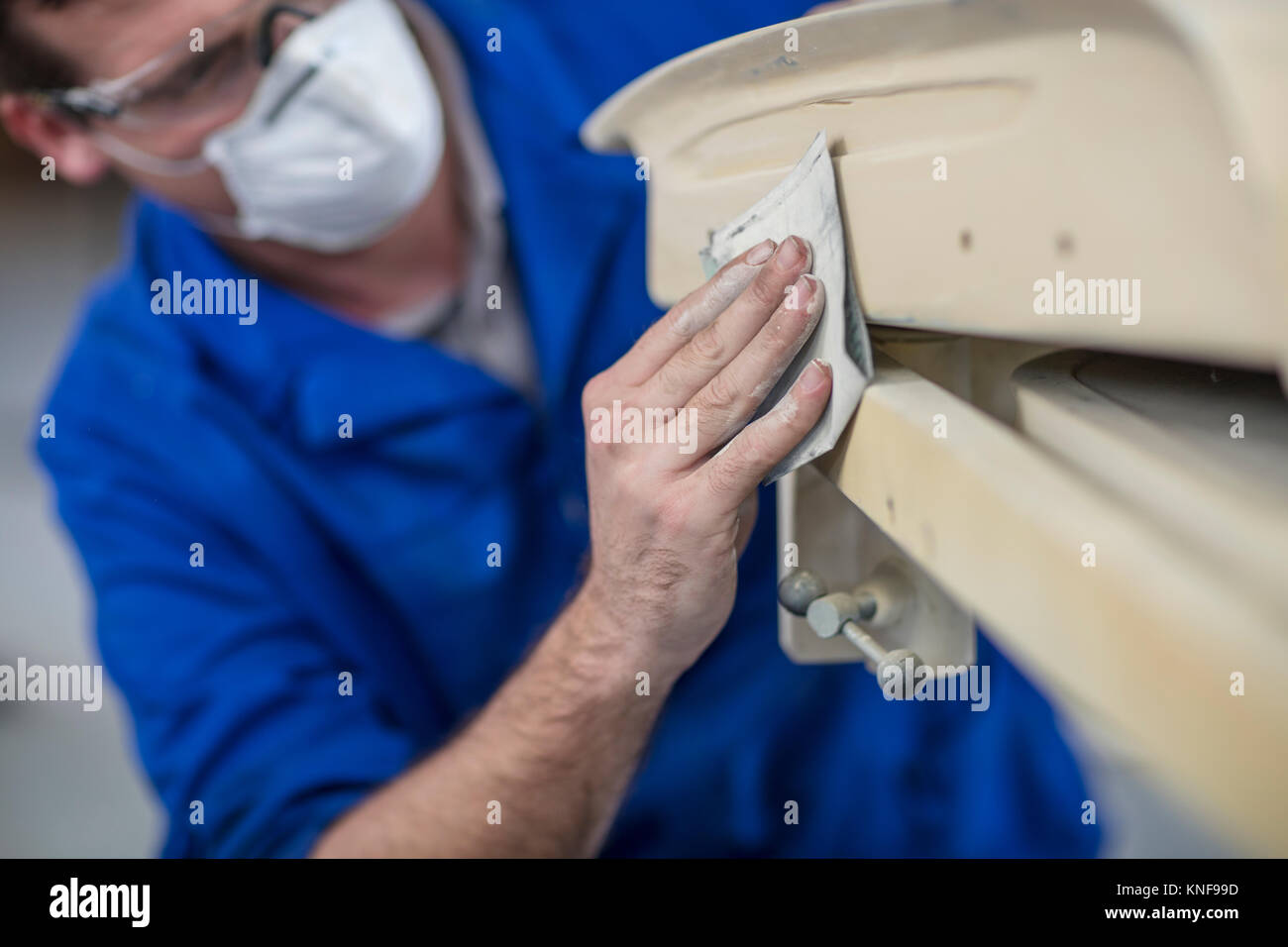 Car mechanic sanding car door in repair garage Stock Photo - Alamy