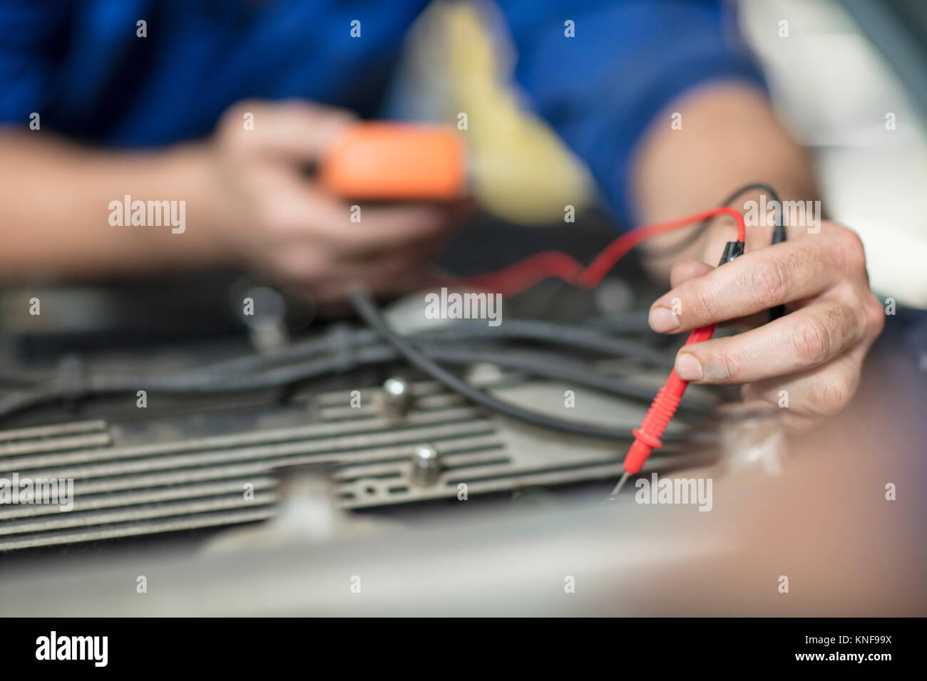 Car mechanic testing car engine in repair garage Stock Photo - Alamy
