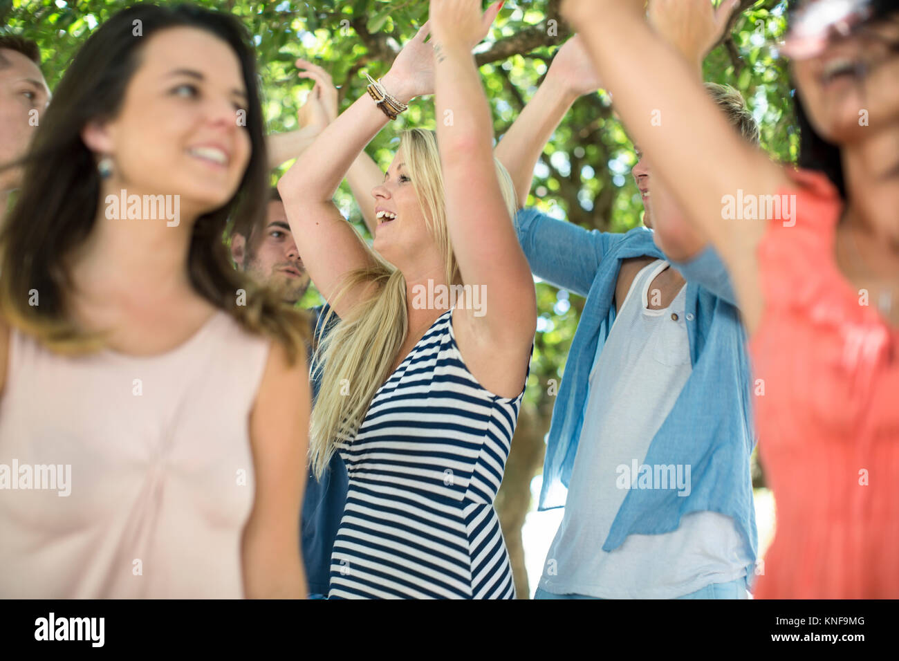 Adult friends dancing together at beach party Stock Photo - Alamy