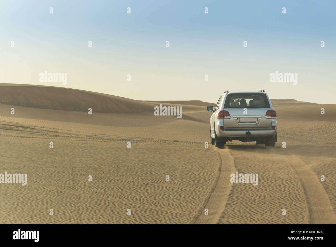 Off road vehicle driving over desert dunes, Dubai, United Arab Emirates ...