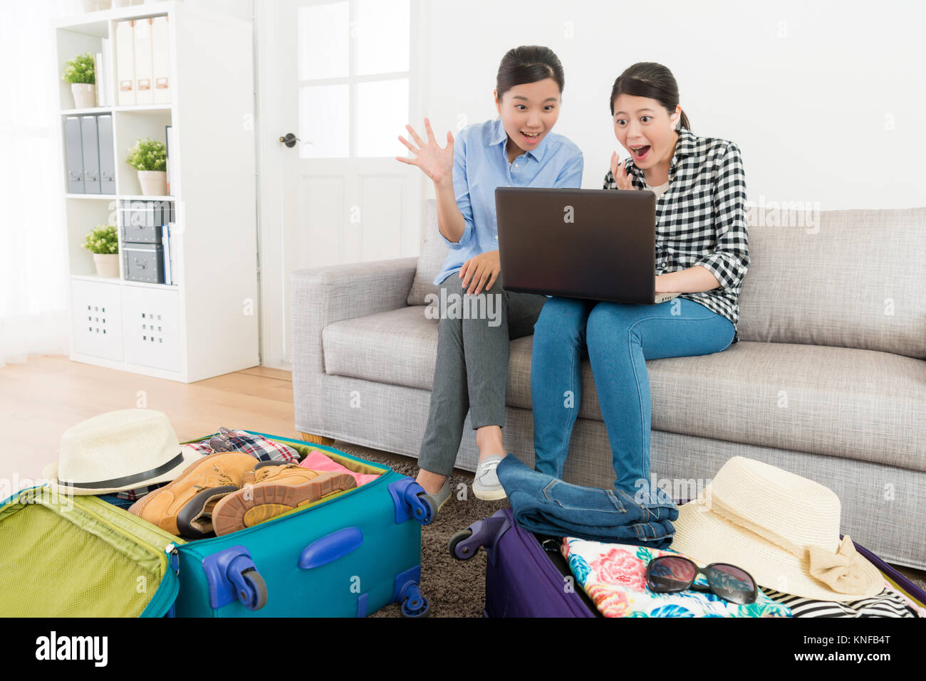 pretty young women friends looking at computer screen feeling surprised ...