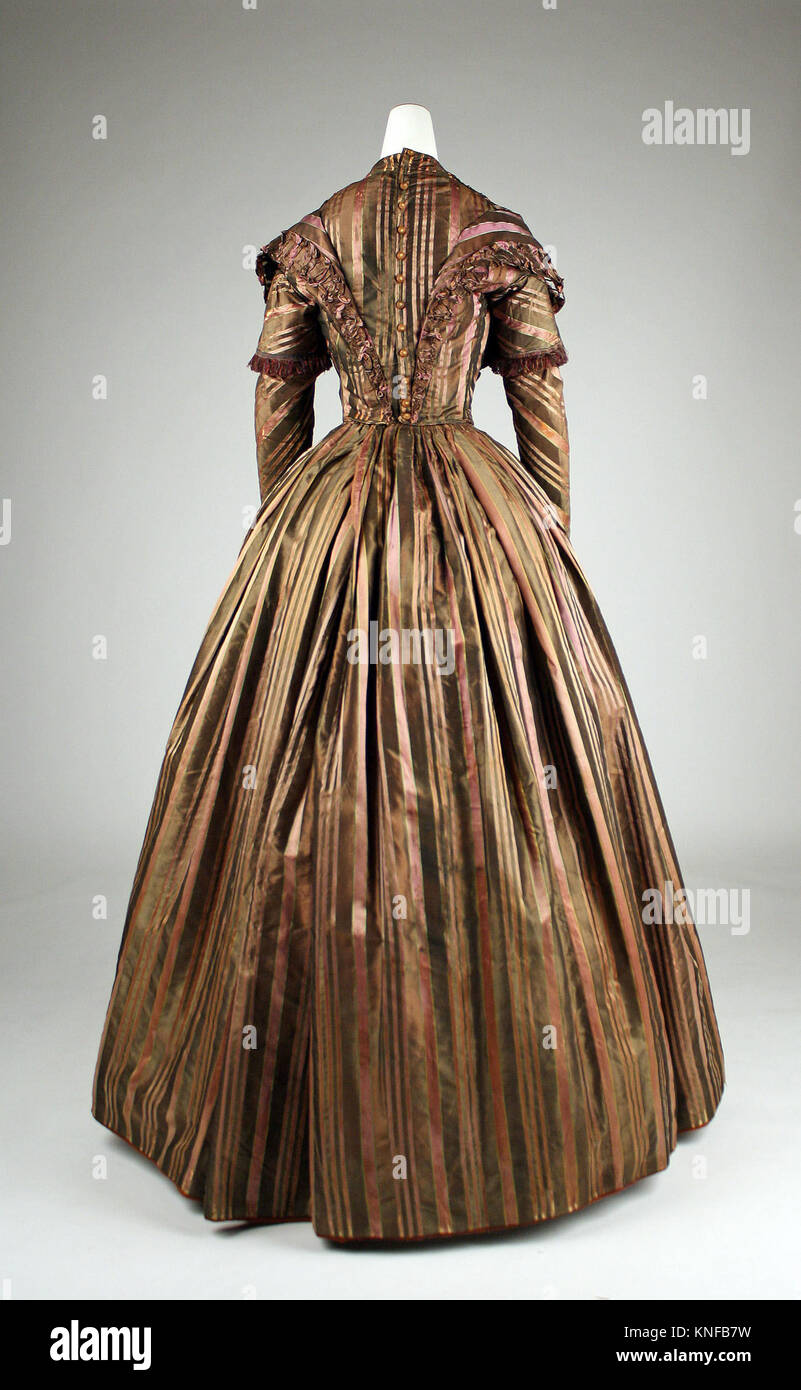 A vintage dress showcasing period fashion, reflecting the design and ...