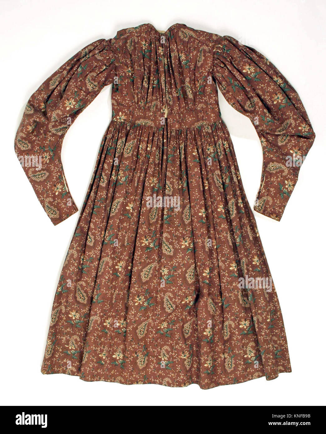 This dress, from a past era, showcases the fashion and textile ...