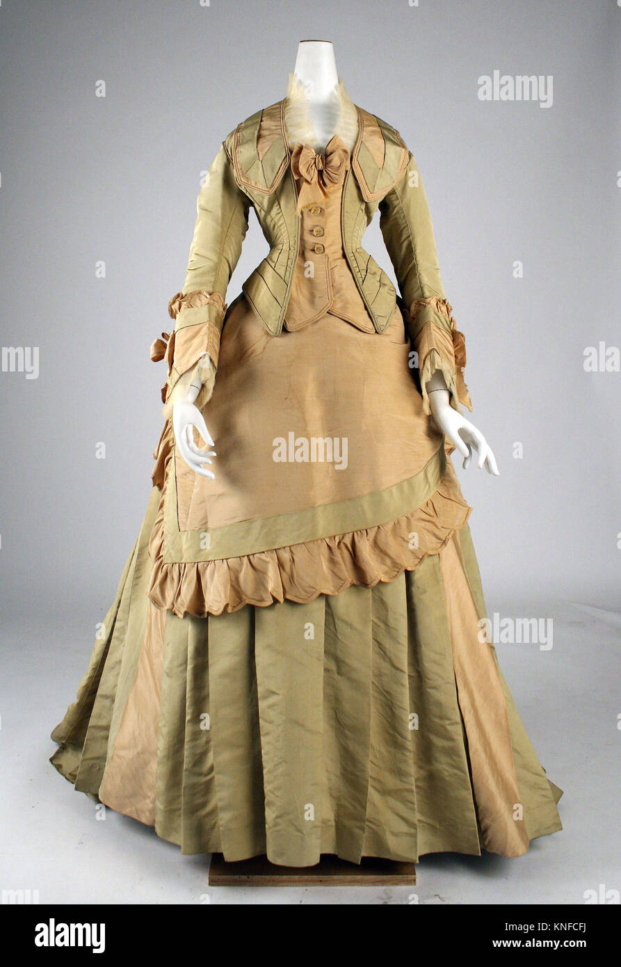 This dress is a fine example of historical fashion, showcasing detailed ...