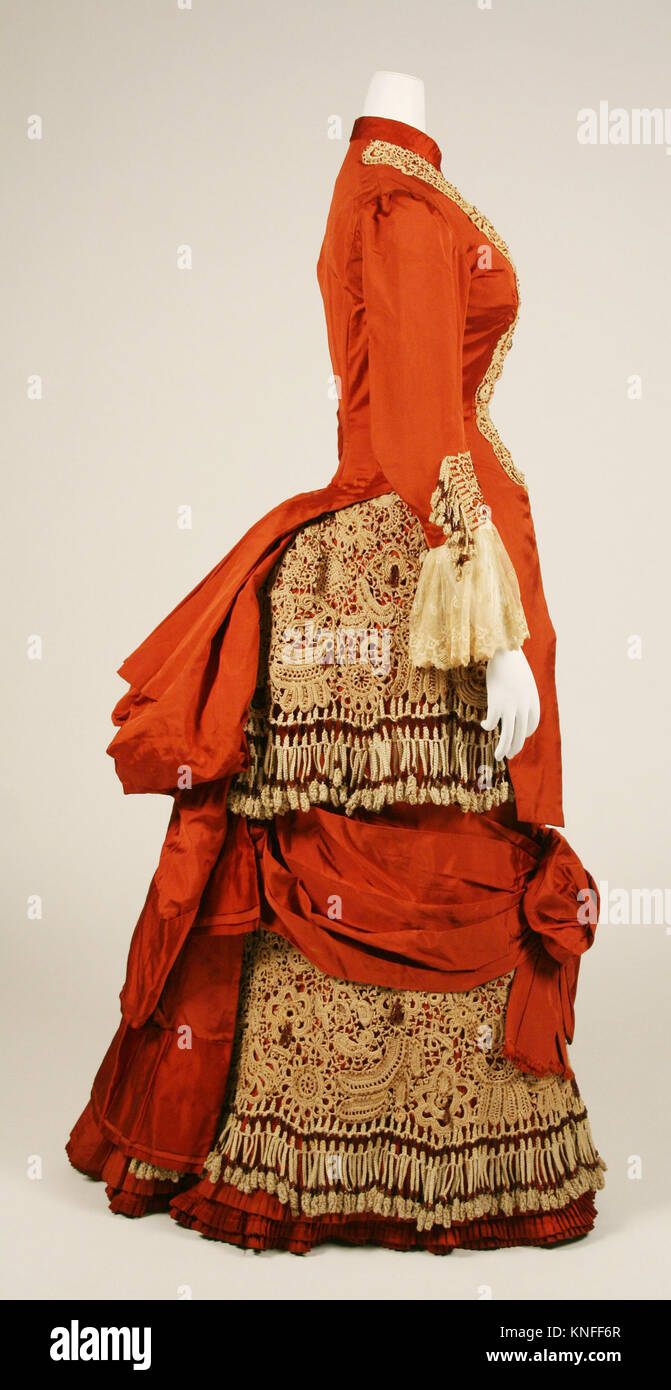 This dress showcases the textile design and fashion of its time, with ...