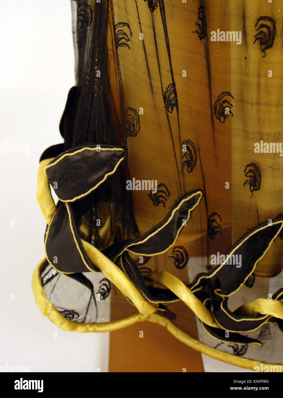 This dress, a historical garment from a specific period, is notable for ...