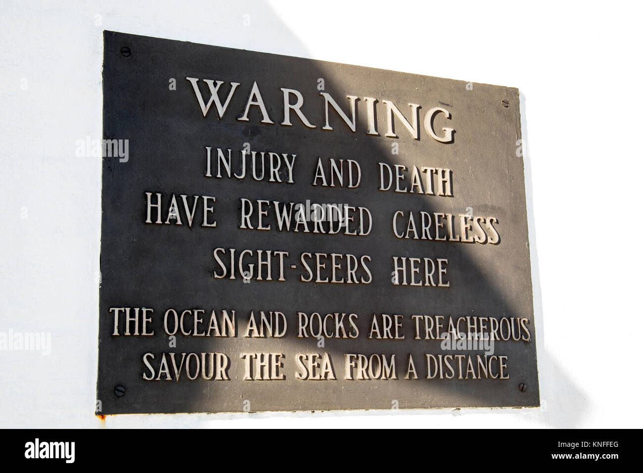Caution sign warning of dangers outside coastal lighthouse in Canada ...