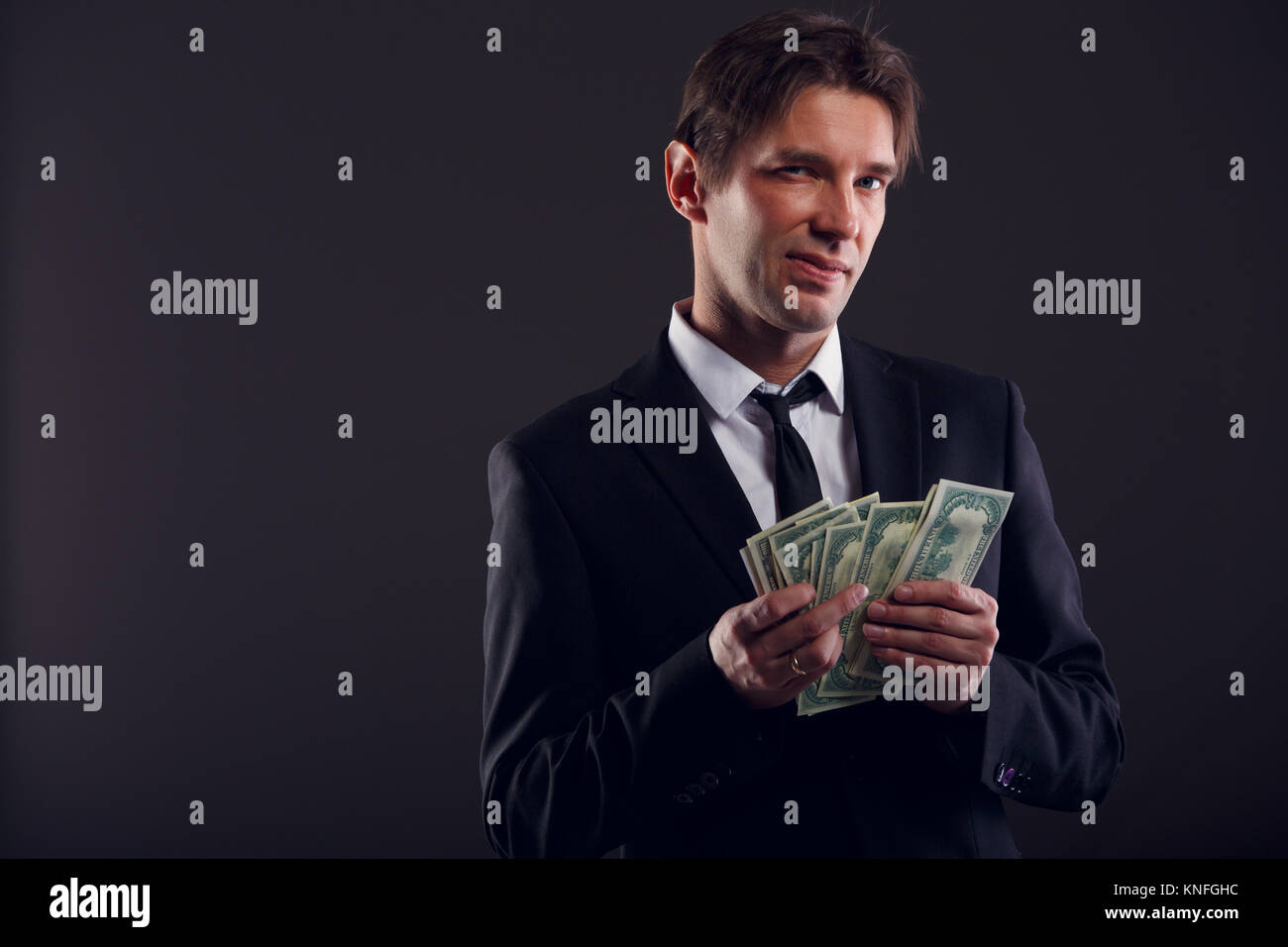Photo of man in suit counting dollars Stock Photo - Alamy