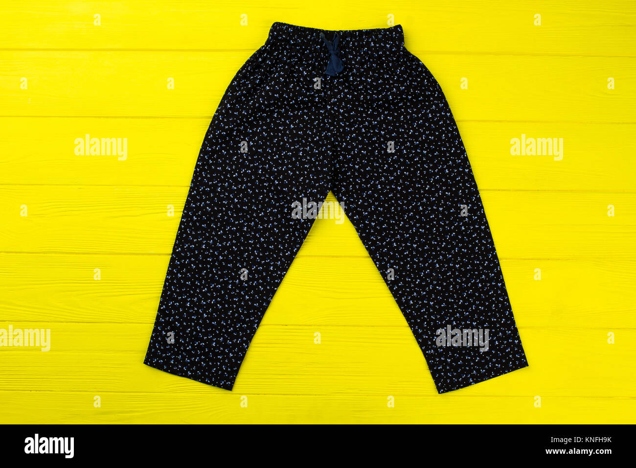 Floral pants on yellow table Stock Photo - Alamy