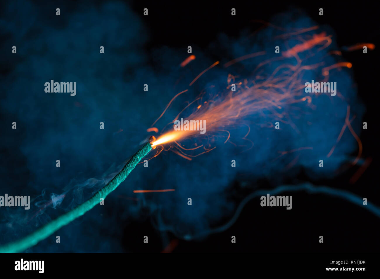 Burning fuse with sparks and blue smoke on black background Stock Photo ...