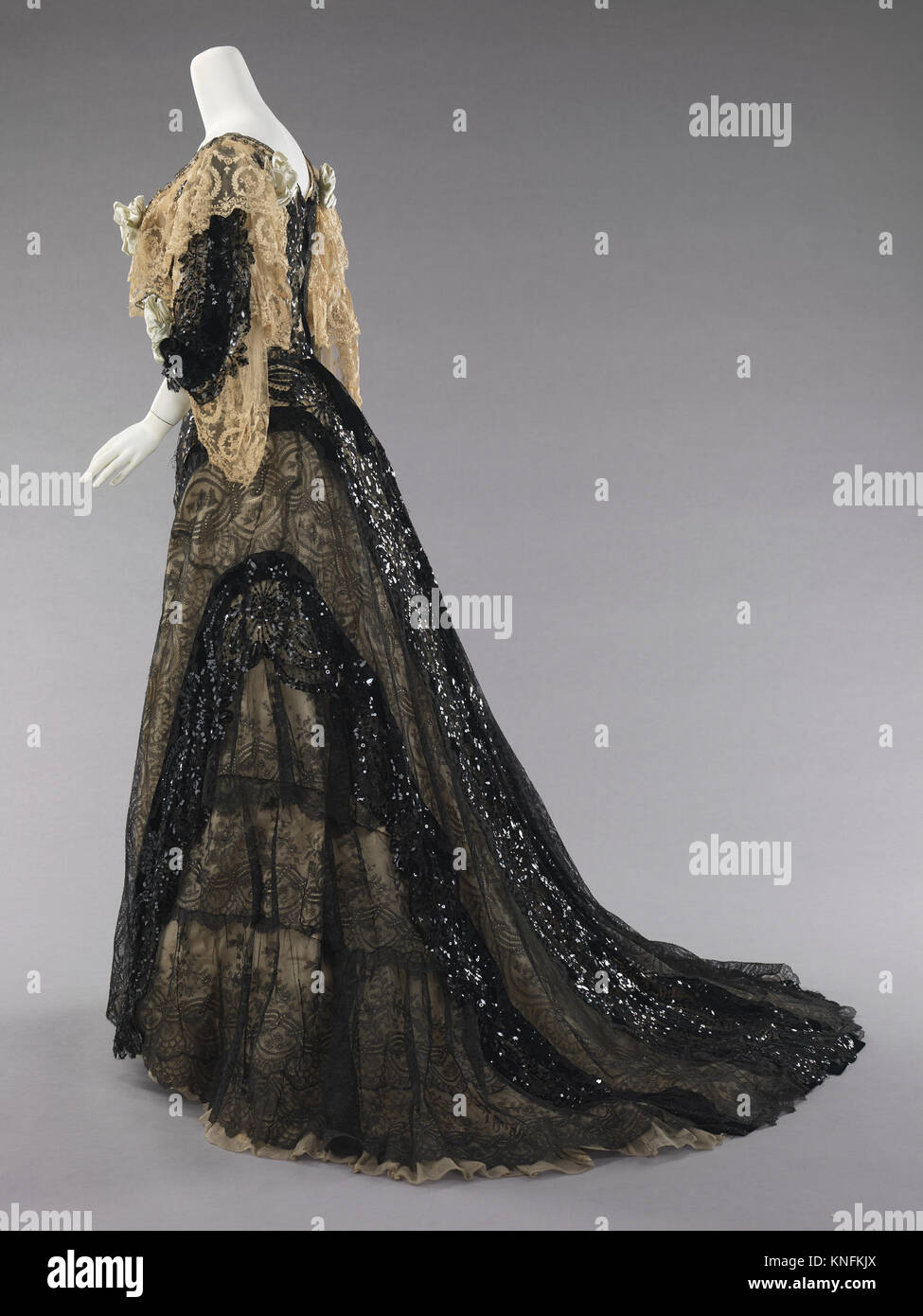 This evening ensemble reflects the fashion and design of its period ...