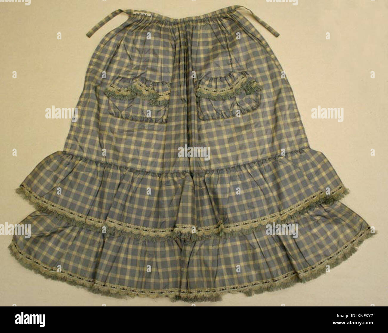 An apron from the early 20th century, made from durable material. This ...