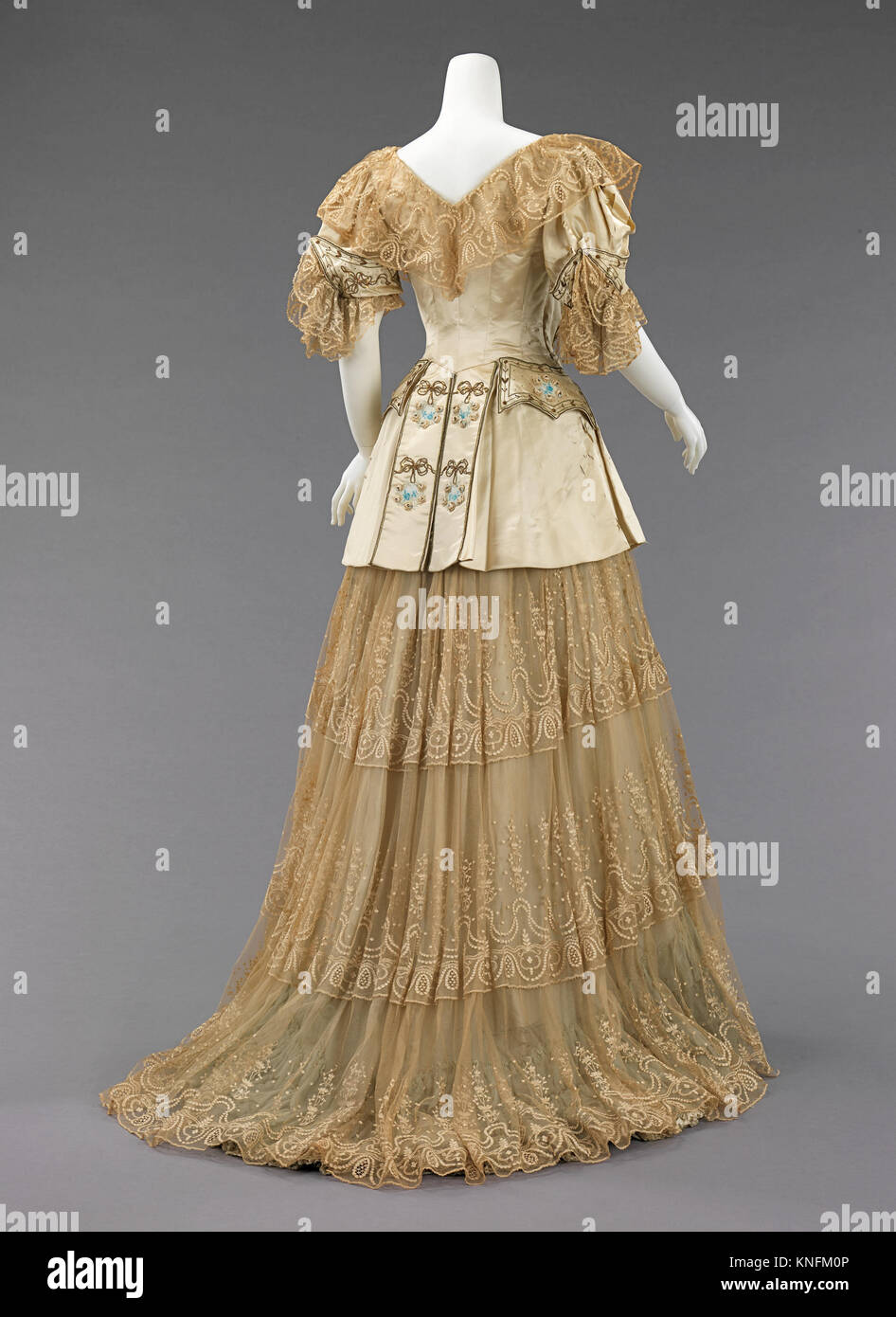 This elegant evening dress features exquisite tailoring and design ...