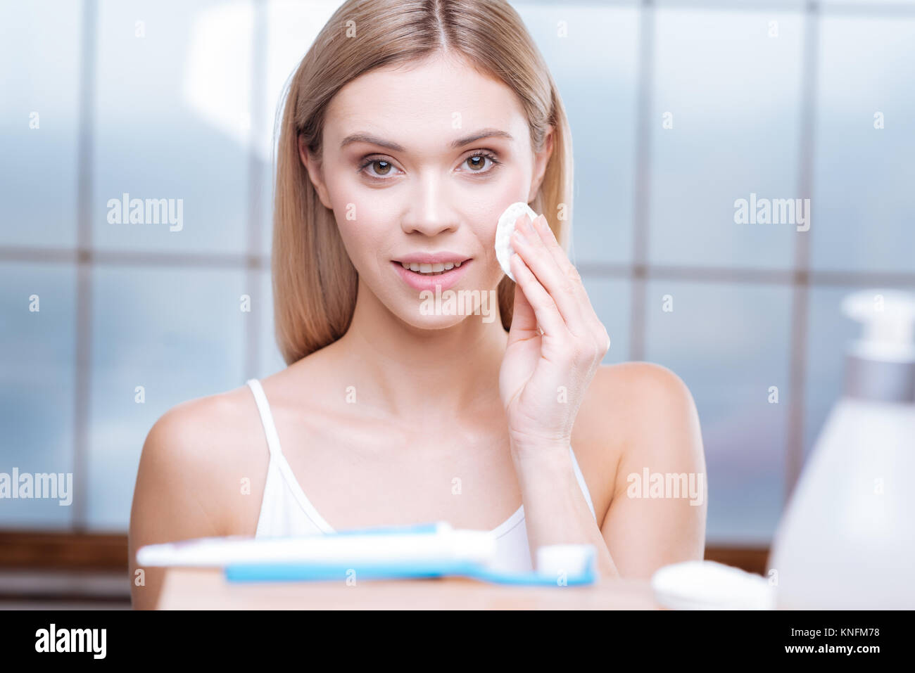 Pretty young woman removing makeup from her skin Stock Photo - Alamy