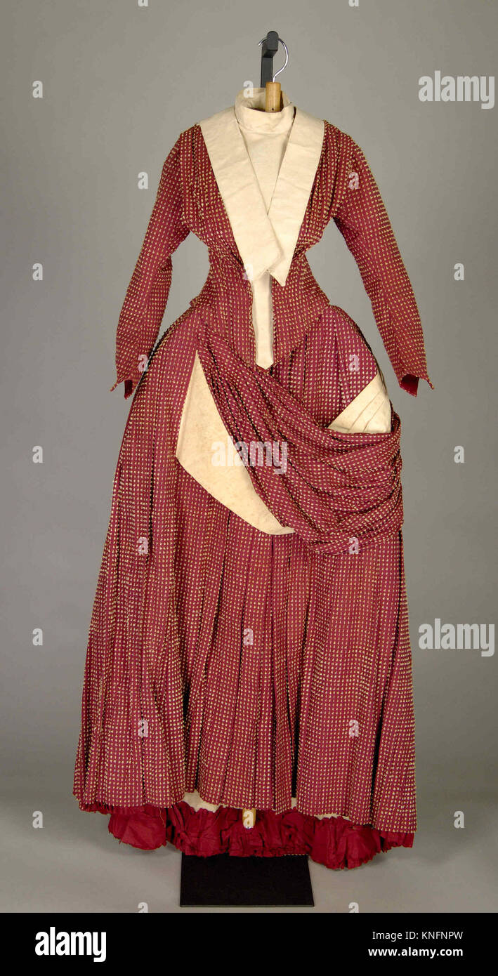 A historical dress featuring design elements typical of its period. The ...