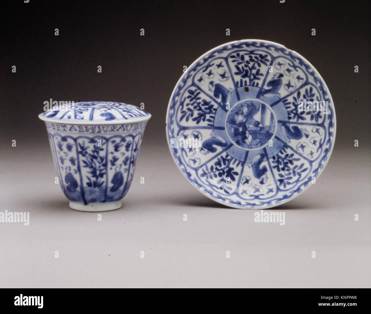 This ceramic beaker with cover and saucer demonstrates fine ...