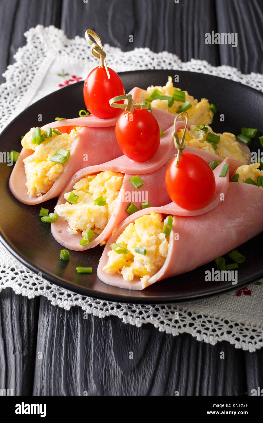 Festive snack: roll ham stuffed with scrambled eggs and tomatoes close ...