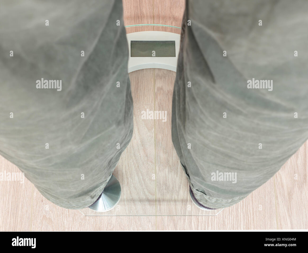 Closeup of man's feet on weight scale Stock Photo - Alamy