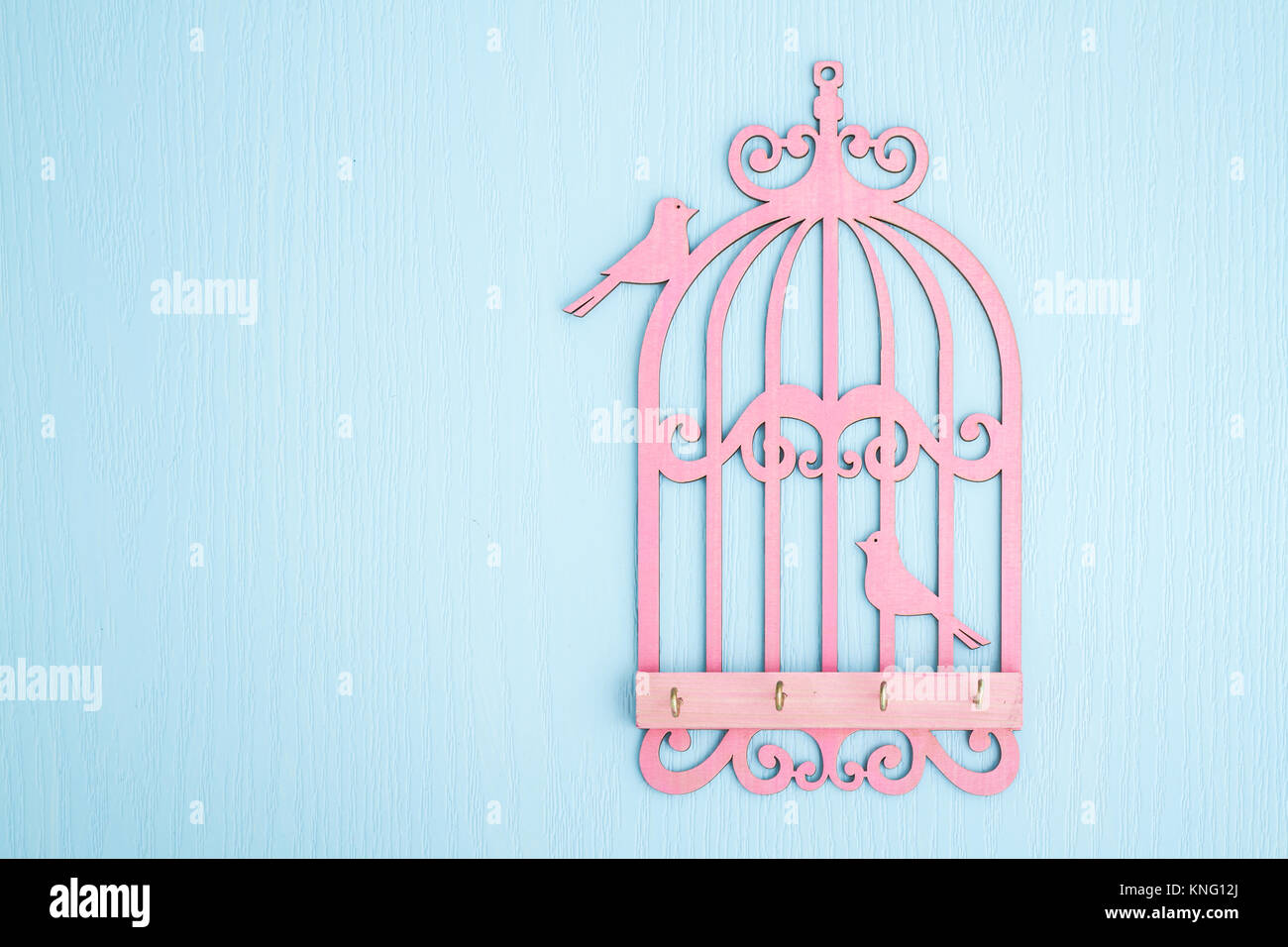Wooden key hangers with bird cage shape on blue wooden background Stock ...