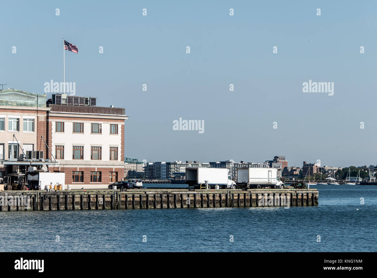 View of harbor from the Boston Waterfront with fishing boat trucks and ...