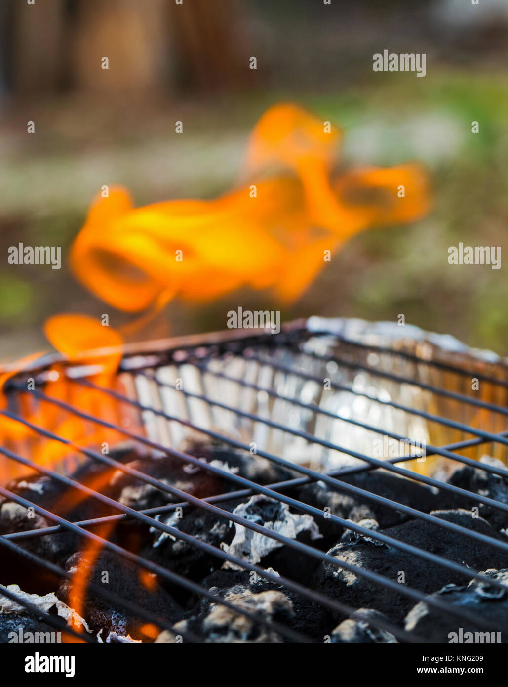 Burning flames and barbecue closeup Stock Photo - Alamy