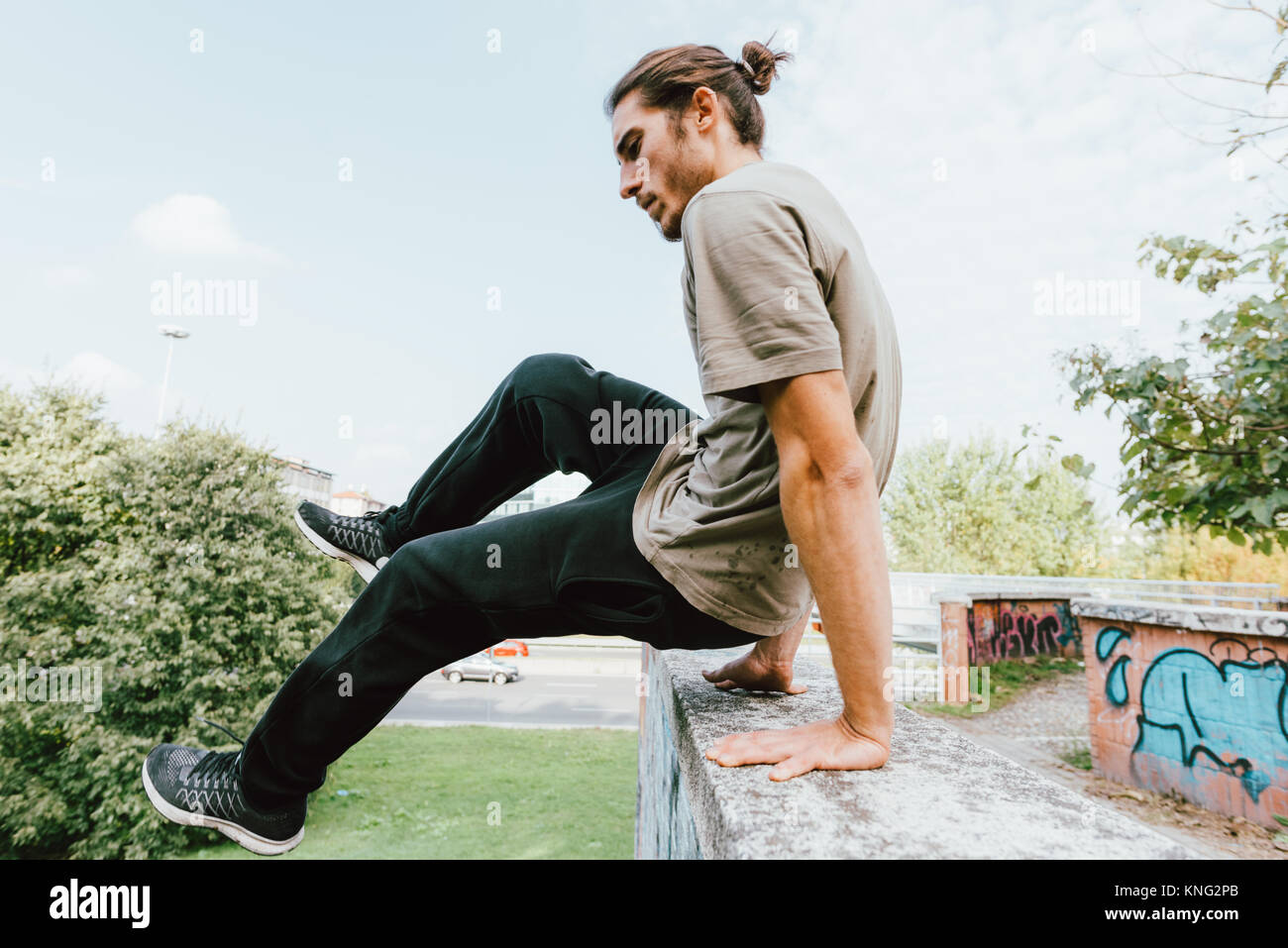 Young beautiful caucasian man doing parkour outdoor in the city in ...