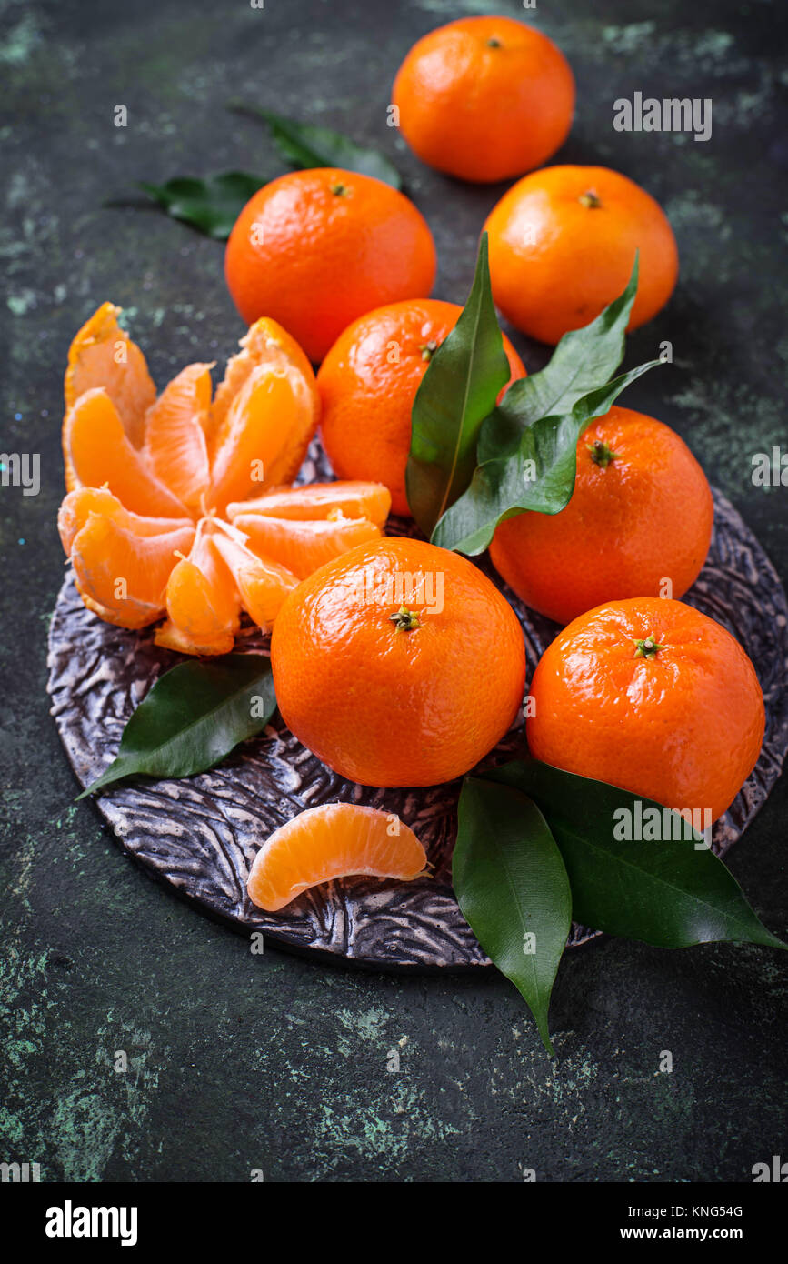 Fresh ripe tangerines with leaves. Selective focus Stock Photo - Alamy