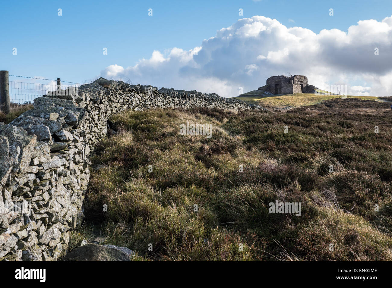 Stone walls with view towards Jubilee Tower, Moel Famau country park ...